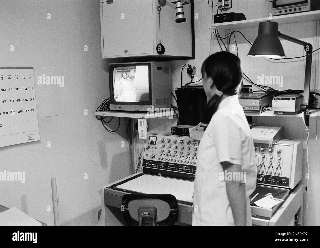 An attendant views a monitor in Dr. Kunihiko Asai's office at the Asai ...