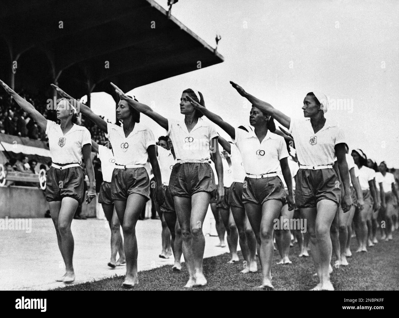 Members of the women's contingent give the Olympic salute at an ...