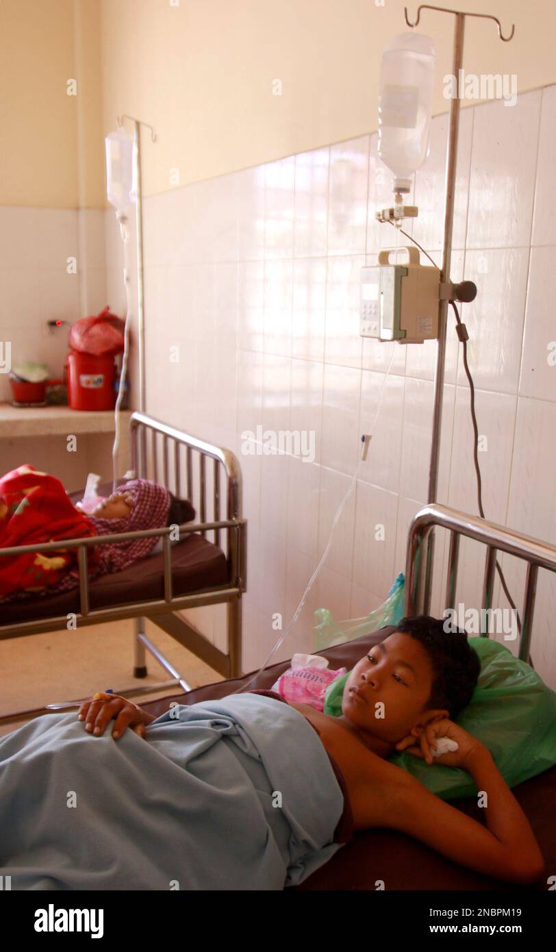 Soung Sokha, foreground, 12, who was infected with dengue fever sleeps ...