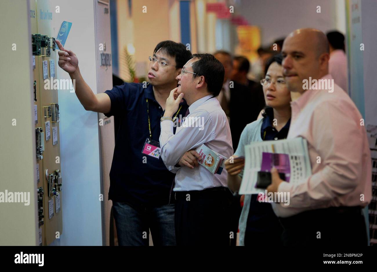 A vendor gives details on computer components during the opening day of ...