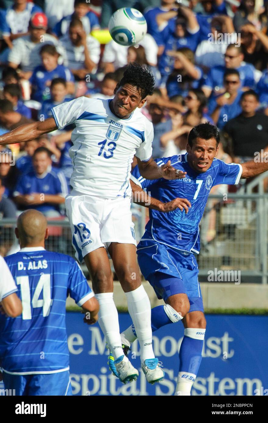 Honduras' Carlo Costly (13) heads the ball away from El Salvador's ...