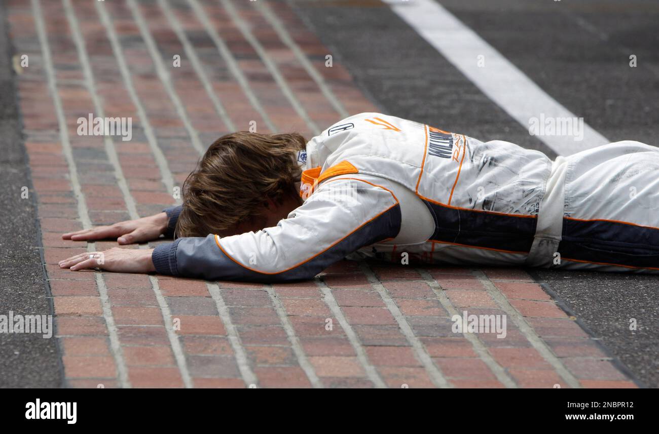 IndyCar driver Dan Wheldon, of England, kisses the yard of bricks at ...