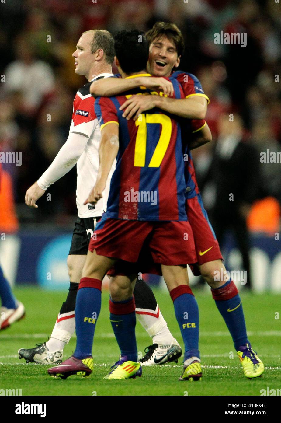 Manchester United's Wayne Rooney, left, reacts as Barcelona's Lionel ...