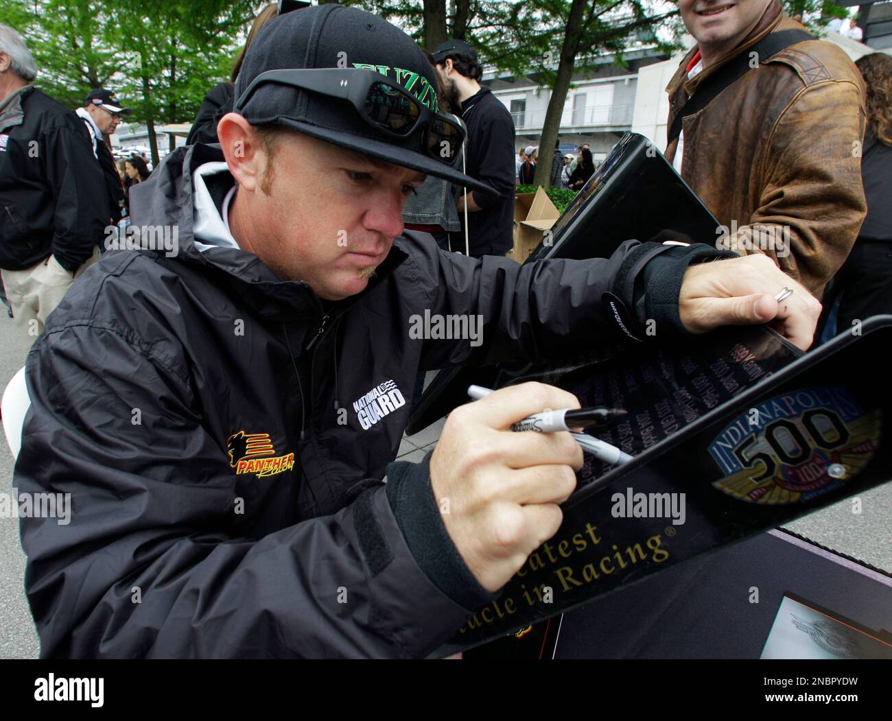 IndyCar driver Buddy Rice signs autographs for fans at the Indianapolis ...