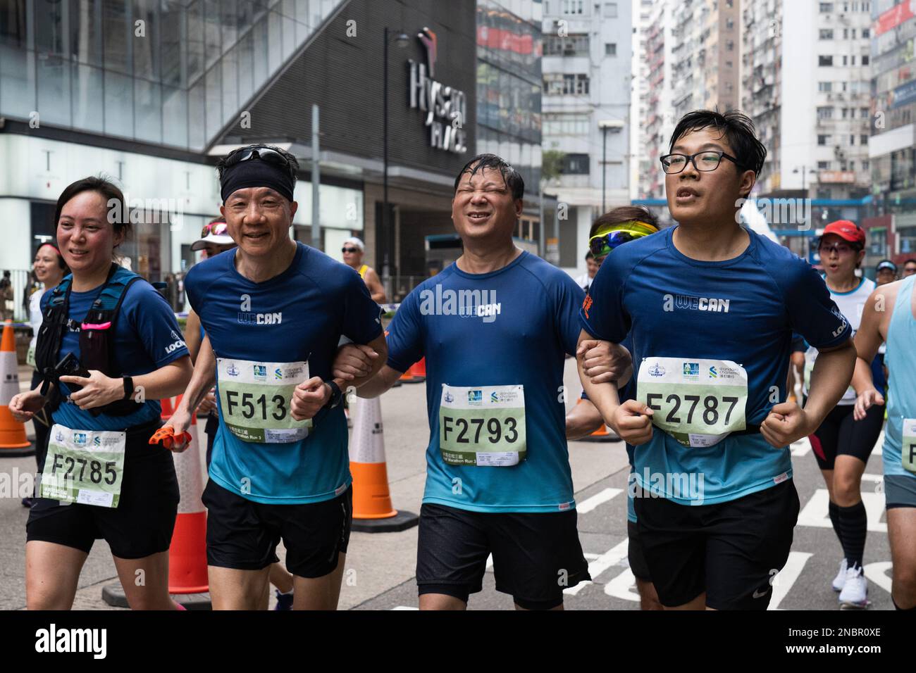 A runner seen holding on to his friends as he struggles to finish the ...