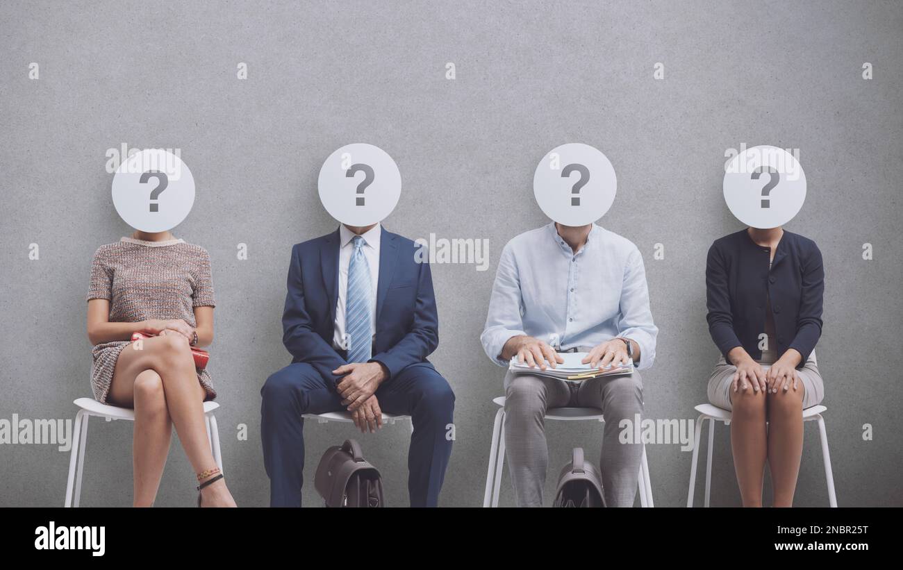 Diverse job candidates sitting in the waiting room and waiting for ...