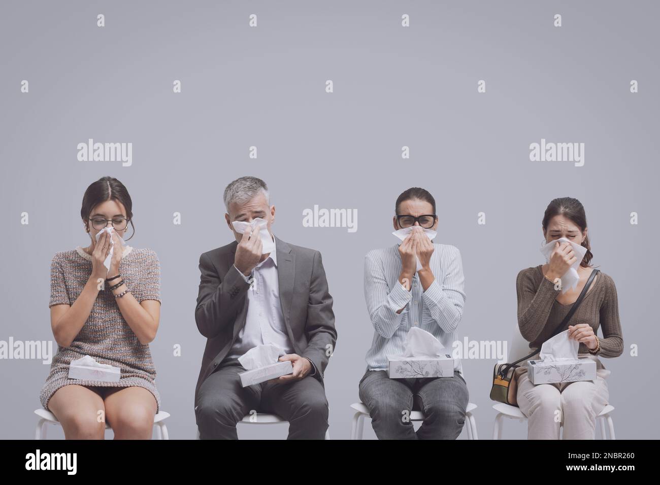 Sick people with cold and flu sitting in the waiting room at the ...