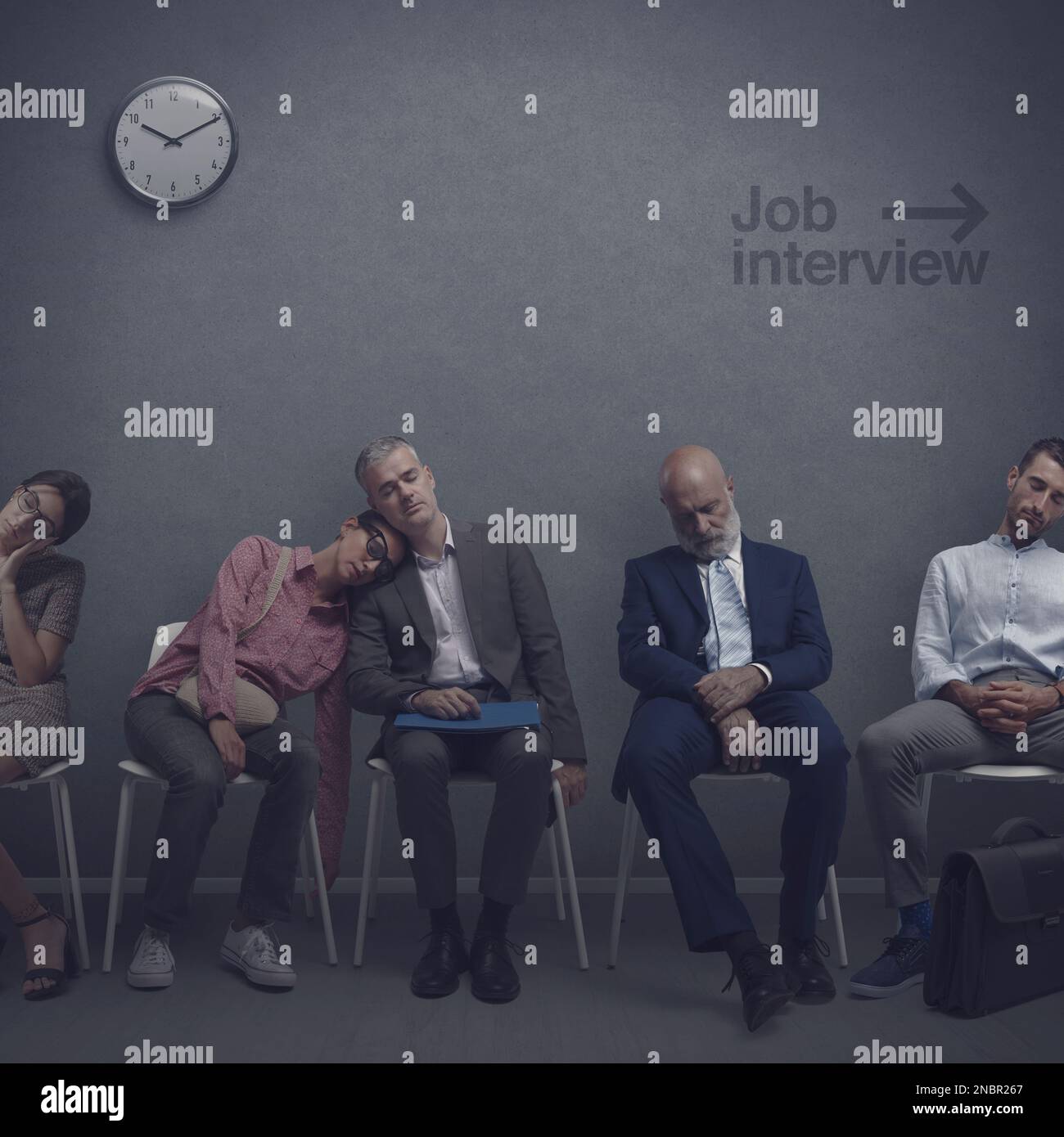 Tired people sitting and waiting in a corporate building late at night ...