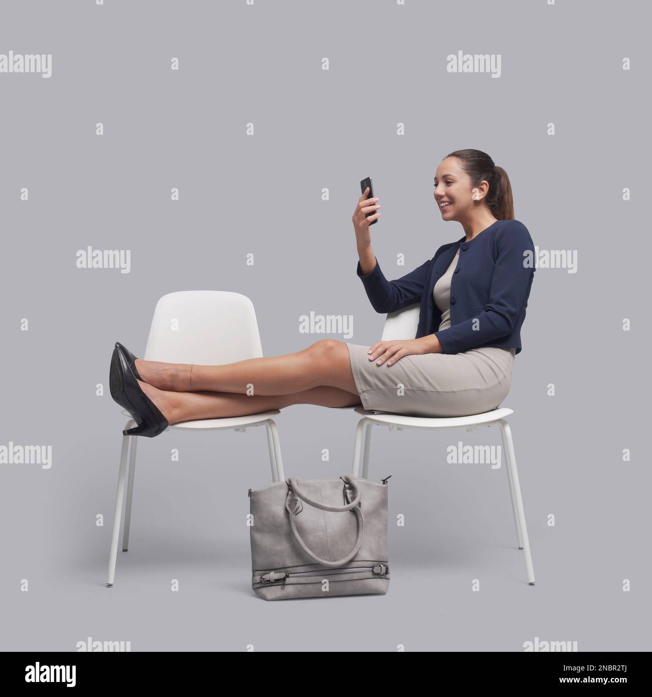 Rude woman sitting with feet up in the waiting room and connecting with ...