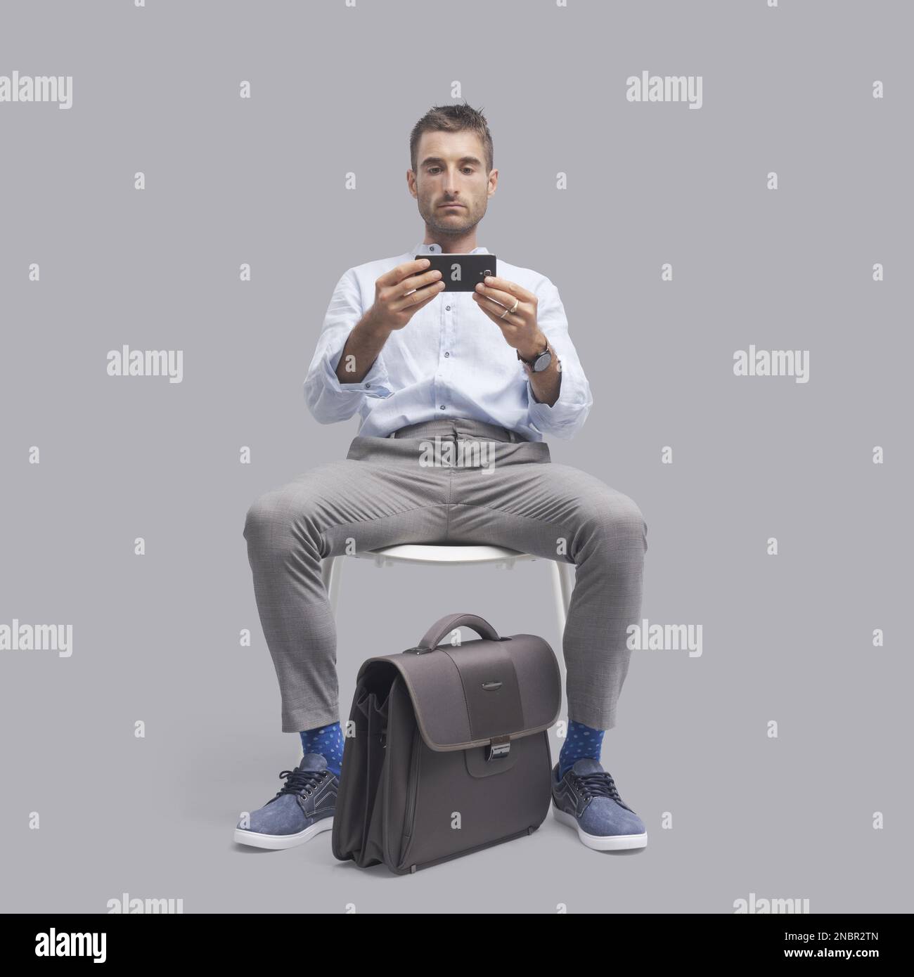 Man sitting on a chair in the waiting room and connecting with his ...