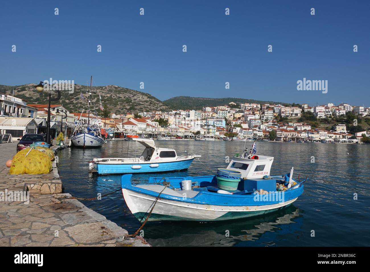 Shot of the small traditional fishing boats in Pythagoreio port with ...