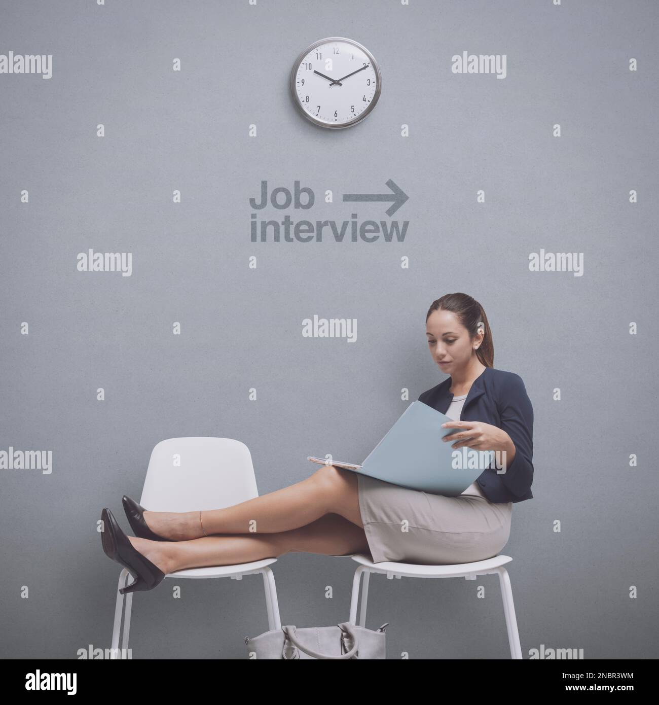 Job applicant sitting with feet up in the waiting room and checking her ...