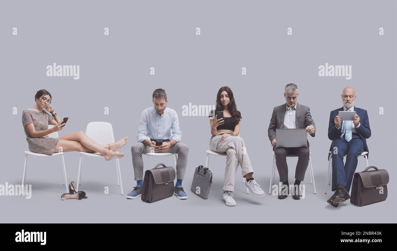 Funny job candidates in the waiting room, they are sitting on chairs ...