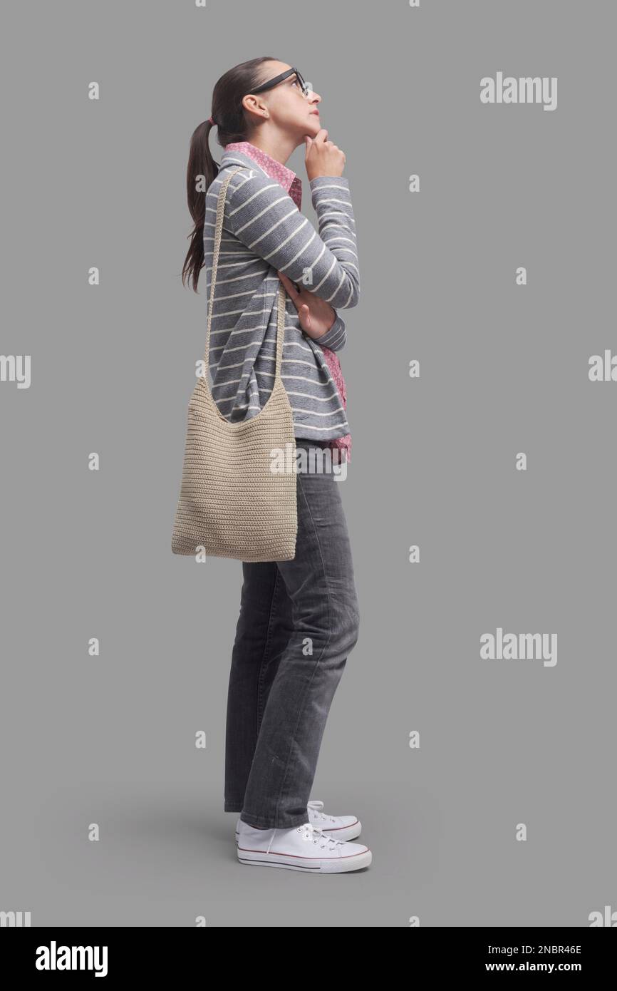Pensive casual woman standing and thinking, full-length portrait Stock ... Pensive casual woman standing and thinking, full-length portrait Stock ...