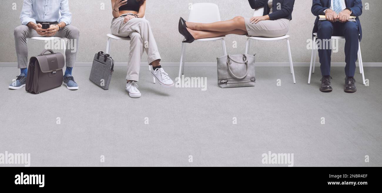 Business people sitting and waiting for a job interview or a meeting ...