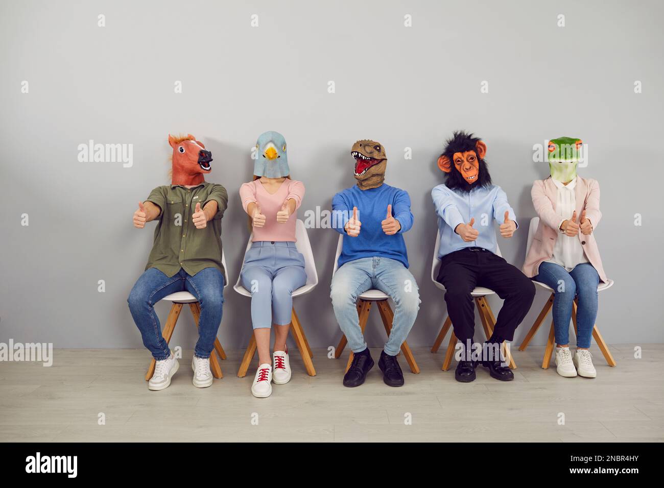 Group of young people in trendy rubber masks of different animals ...