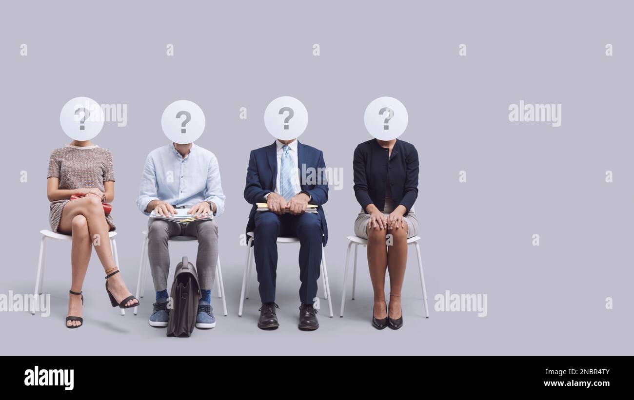 Diverse job candidates sitting in the waiting room and waiting for ...