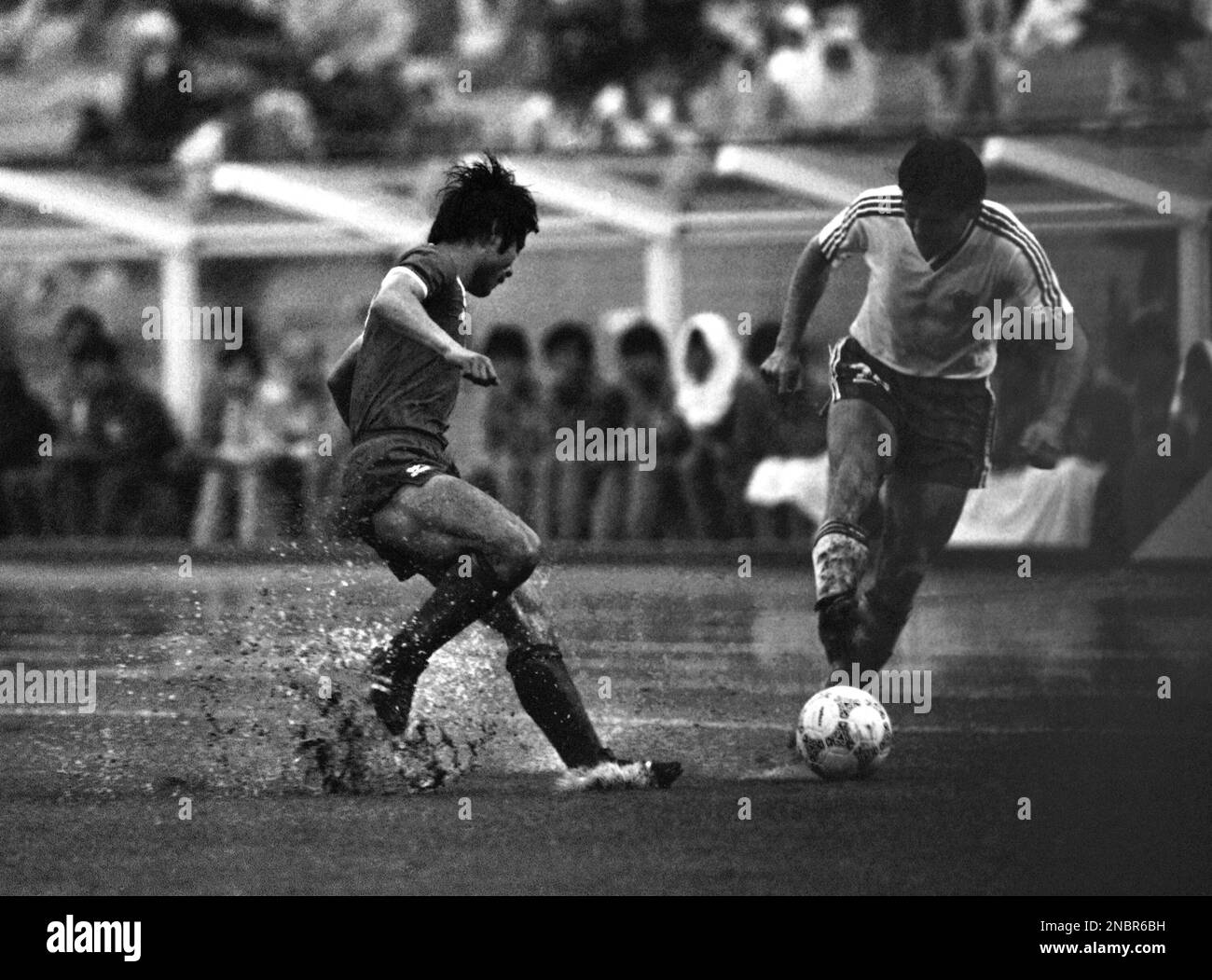 Water splashes under the players feet as tropical rain pours on the ...