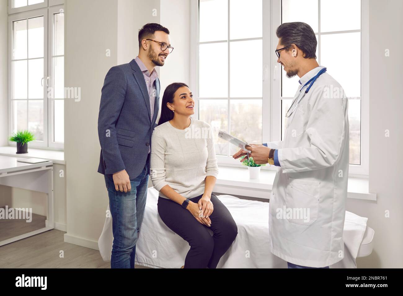 Happy married couple talking with family doctor. Health care and check ...