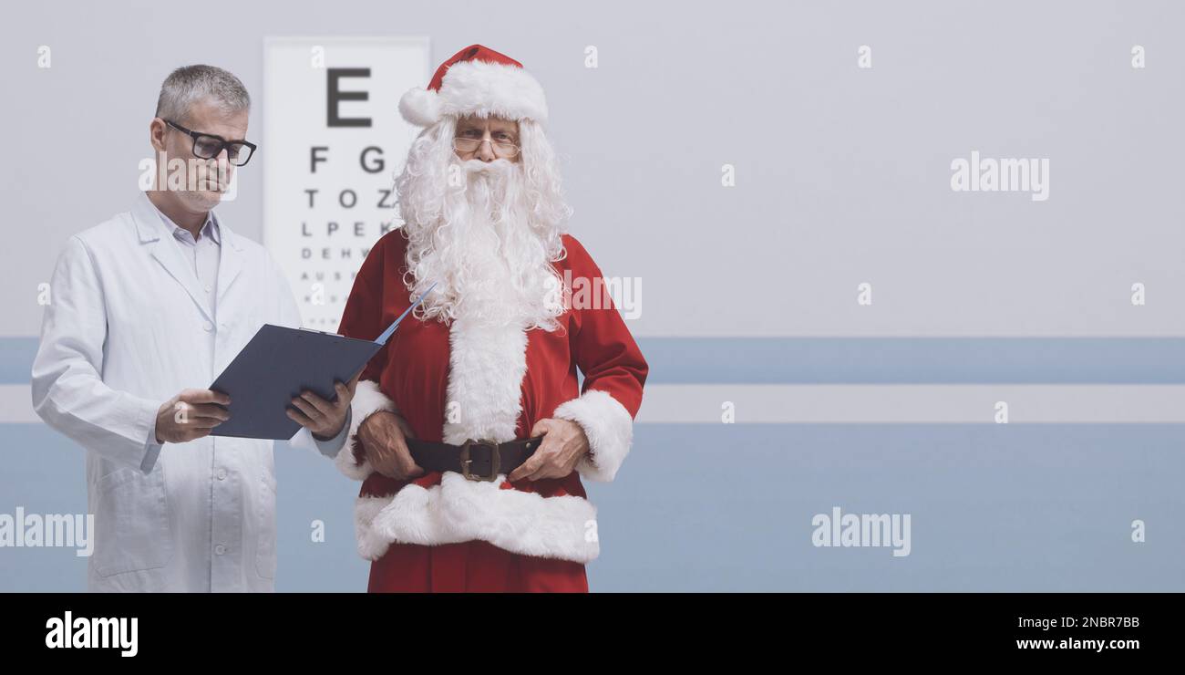 Santa Claus having an eye exam with a professional optometrist, eye ...