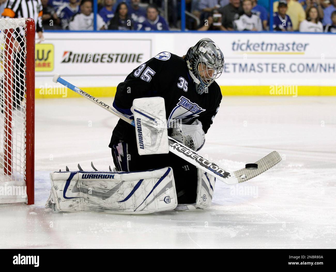 Tampa Bay Lightning goalie Dwayne Roloson blocks a shot by the Boston ...