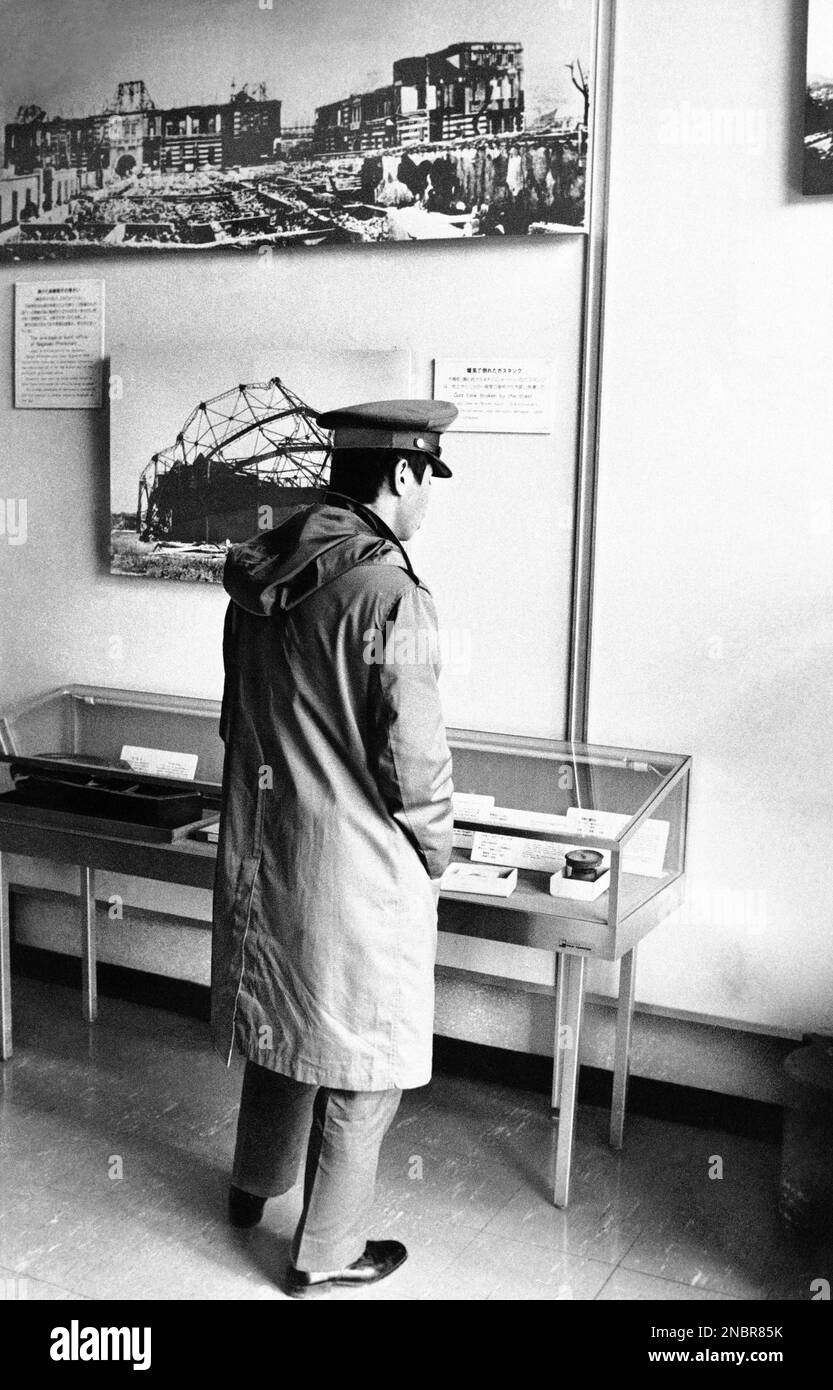 A visitor studies exhibits in Nagasaki's atomic bomb museum which ...