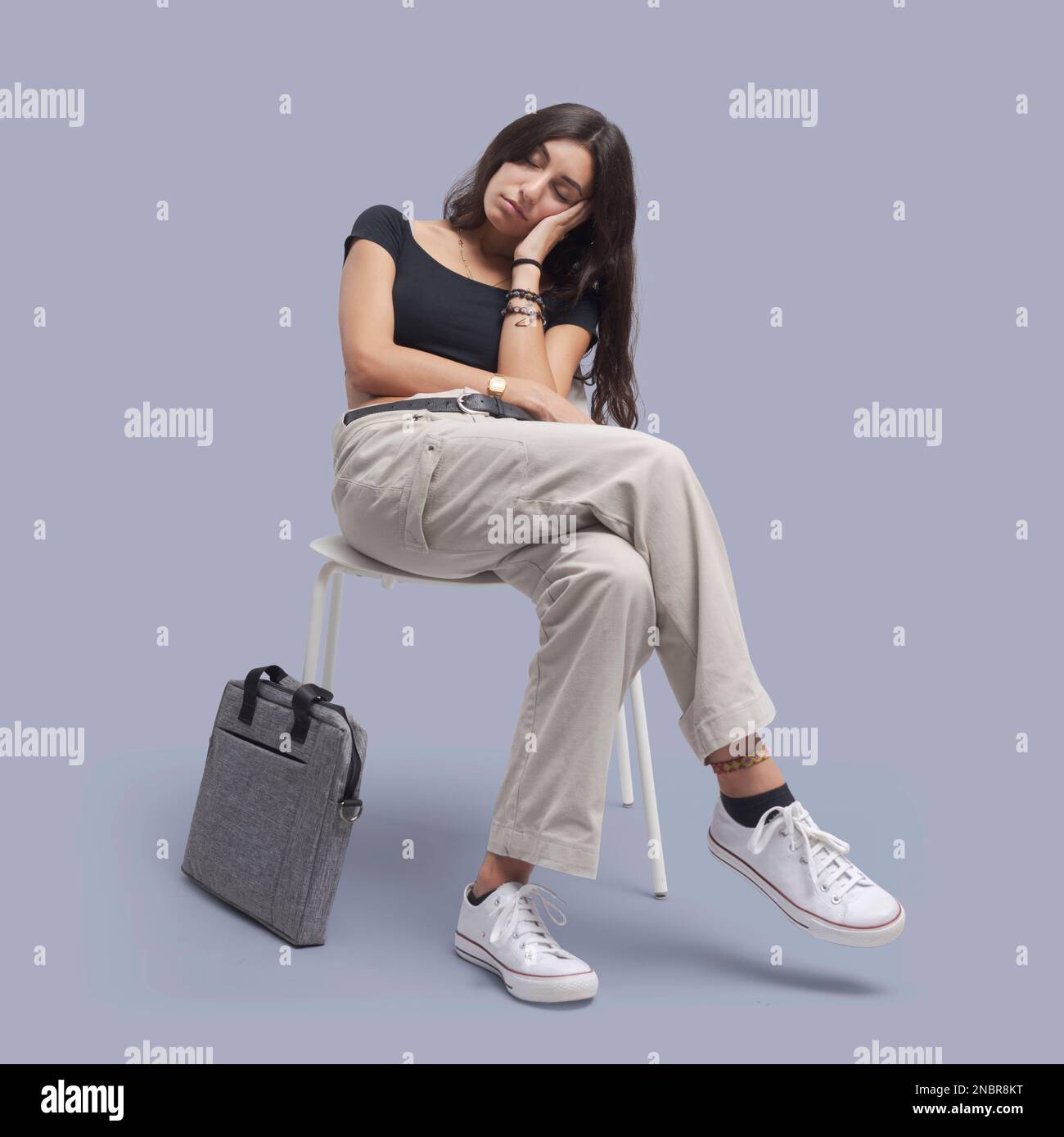 Young tired woman sitting on a chair and sleeping Stock Photo - Alamy