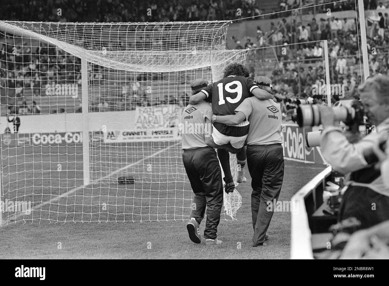 Charlie Nicholas of Scotland is carried out of the field after he tore ...