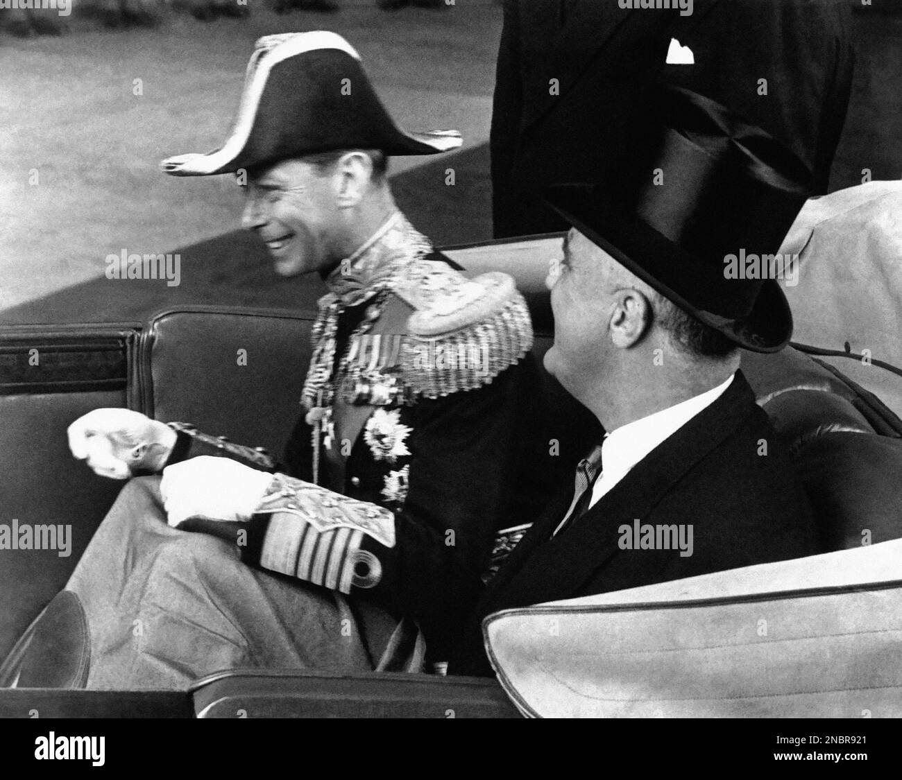 Britain's King George VI, smiling broadly as he drives beside President ...