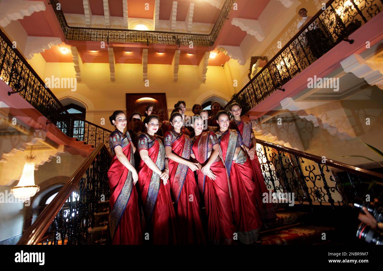 The staff of the Taj Mahal Palace Hotel pose for the media wearing ...