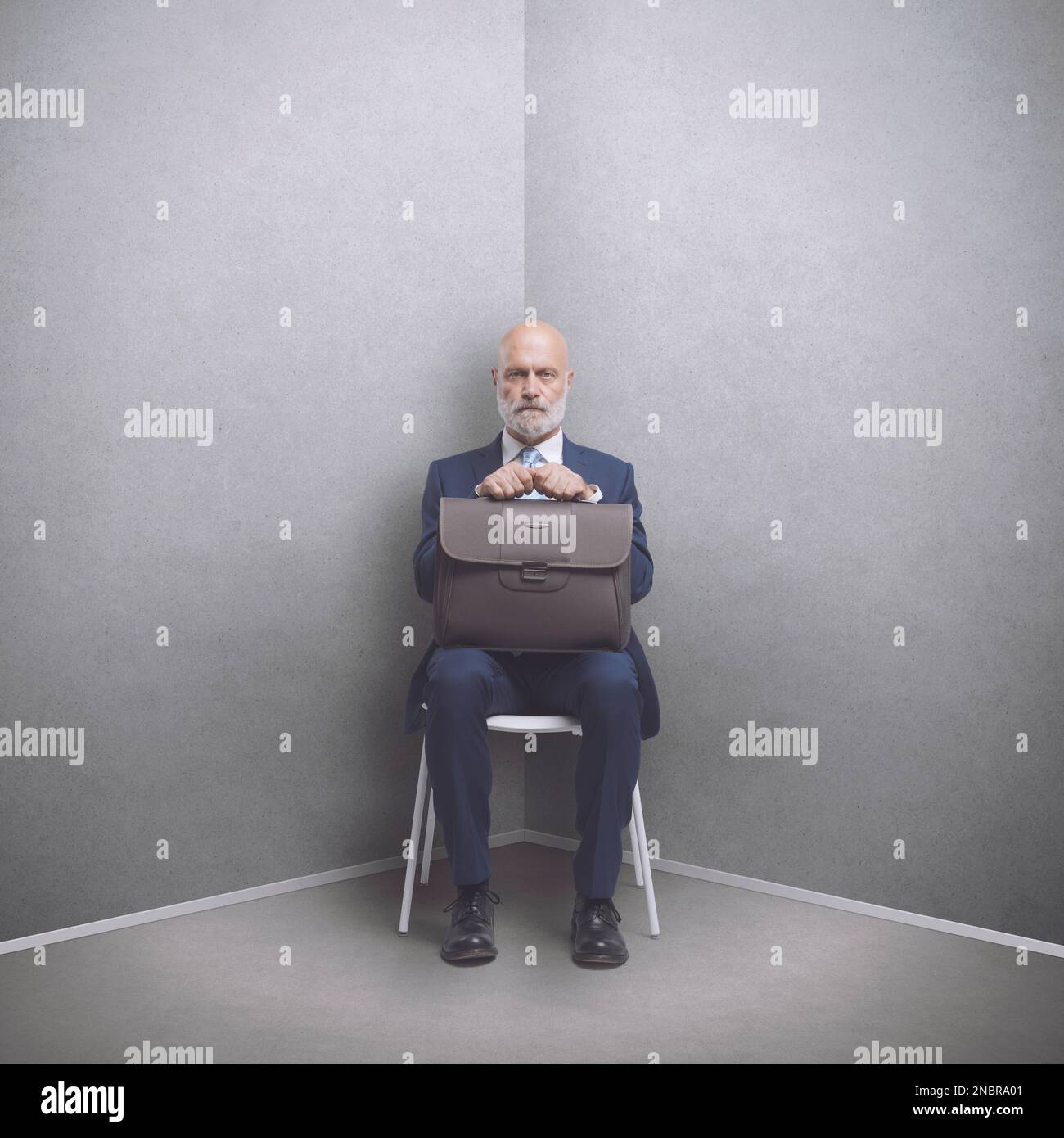 Senior corporate businessman sitting in a corner, job interview and ...