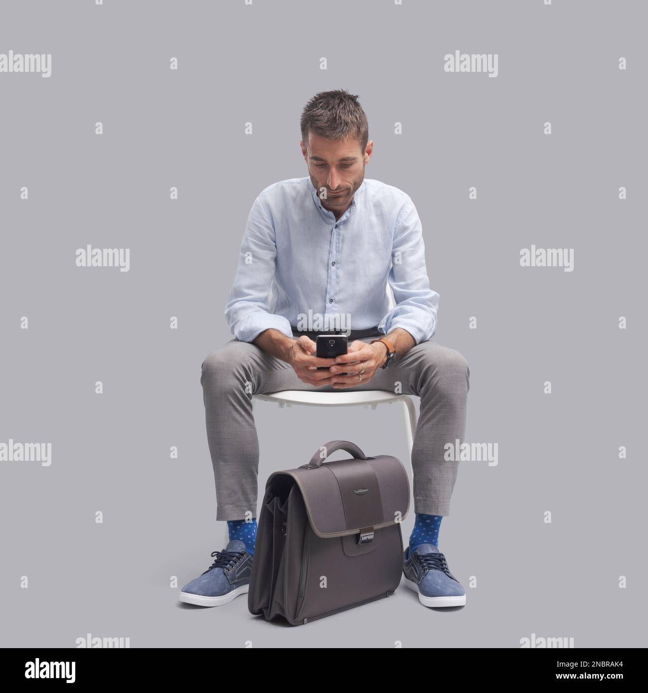 Man sitting on a chair in the waiting room and connecting with his ...