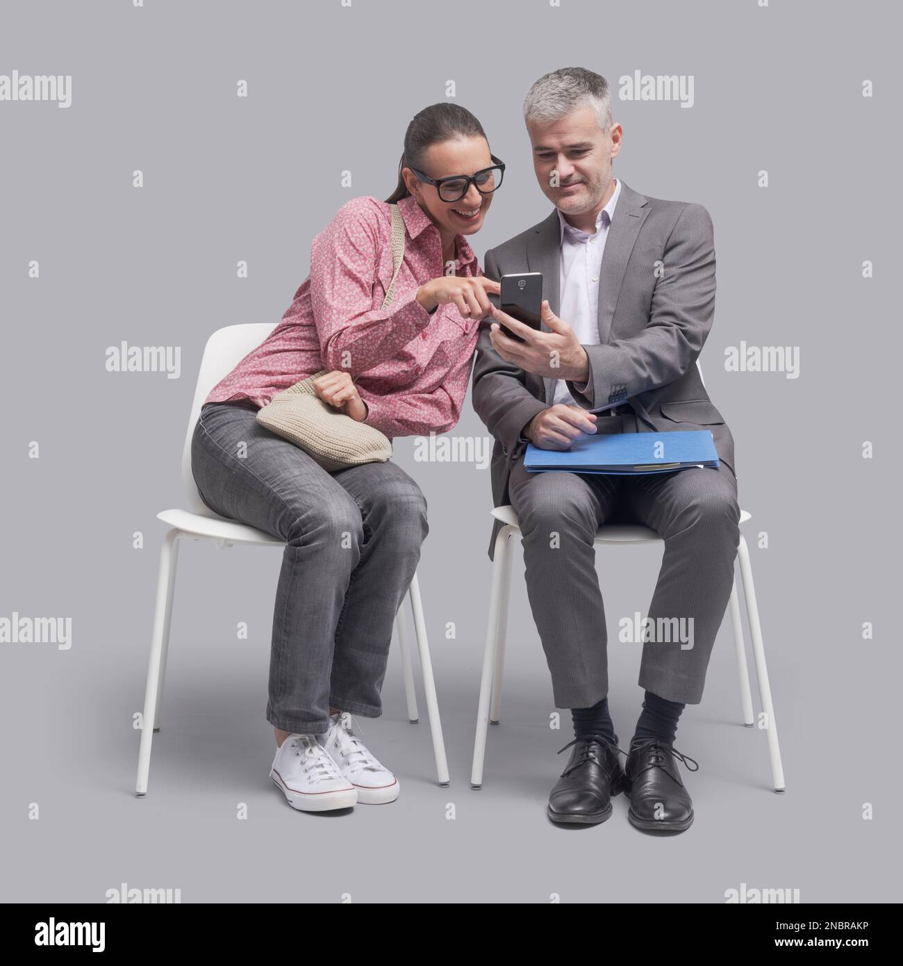 Two friends smiling pointing other hi-res stock photography and images ...