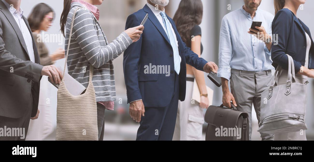 Robber stealing a wallet in the city street, the victim is distracted ...
