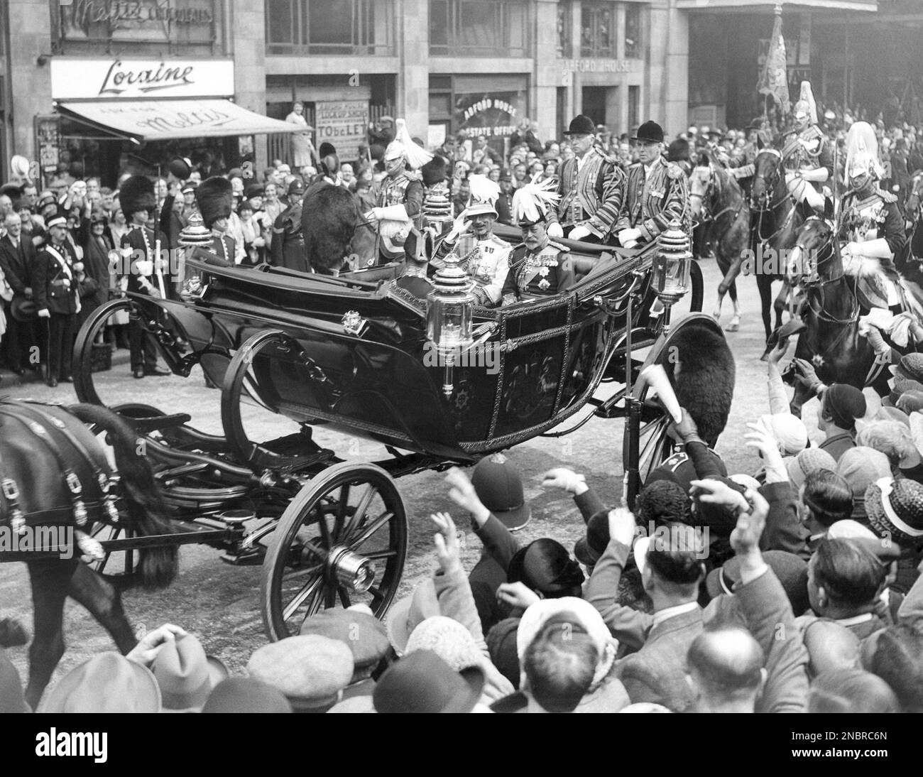 The royal coach with King Feisal of Iraq (saluting), King George V, the ...