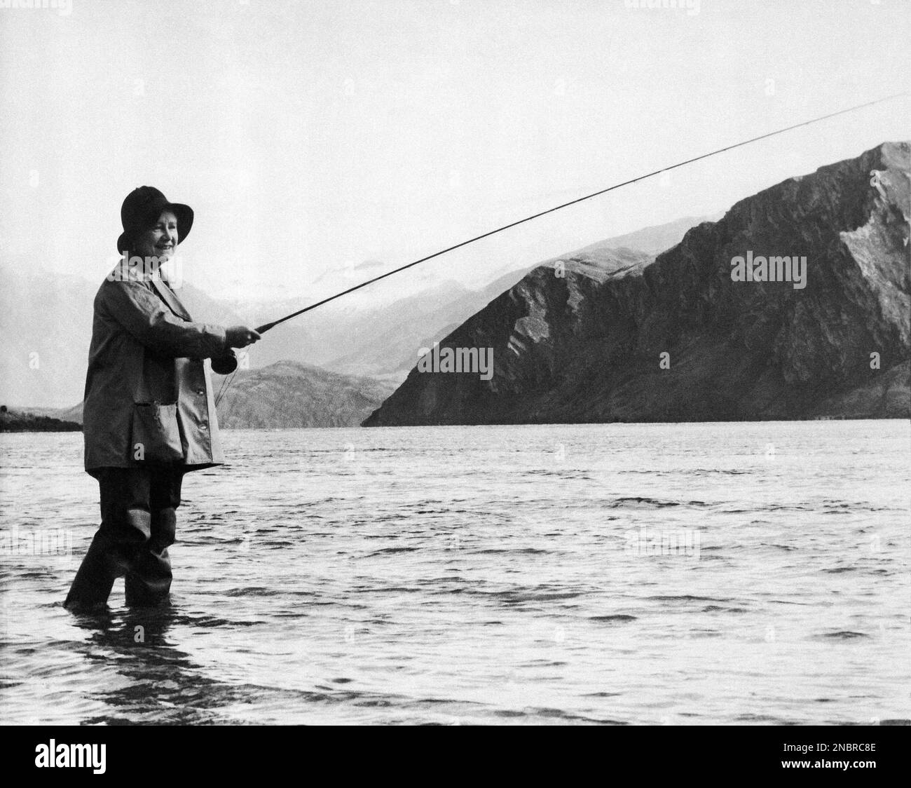 Queen Elizabeth, the Queen Mother fishes for trout at the outlet of the ...