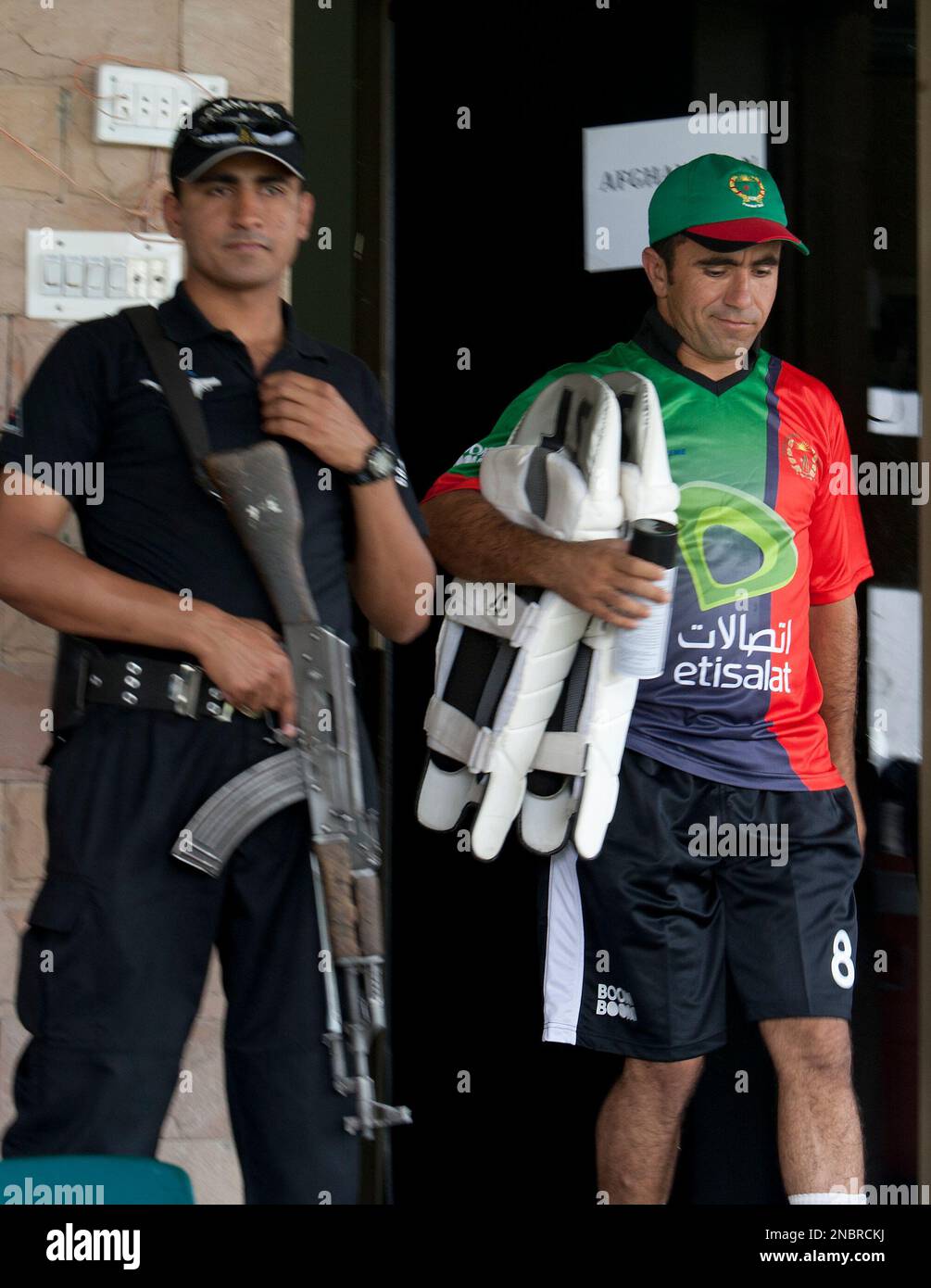 Afghanistan's opening batsman Karim Sadiq, right, leaves for practice ...