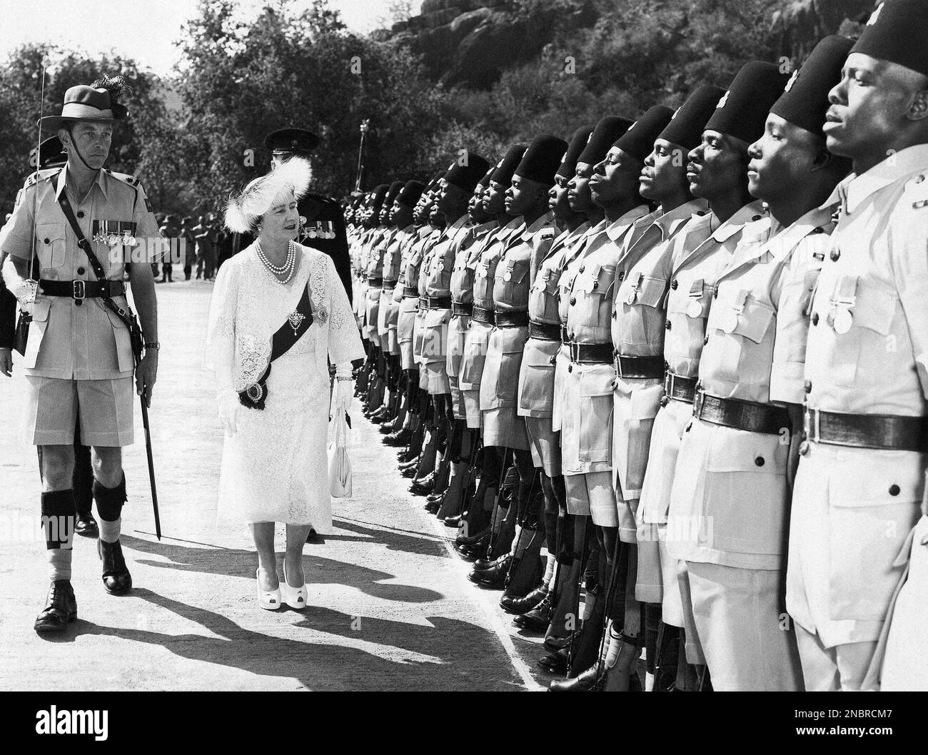 Queen Elizabeth, the Queen Mother accompanied by the guard commander ...