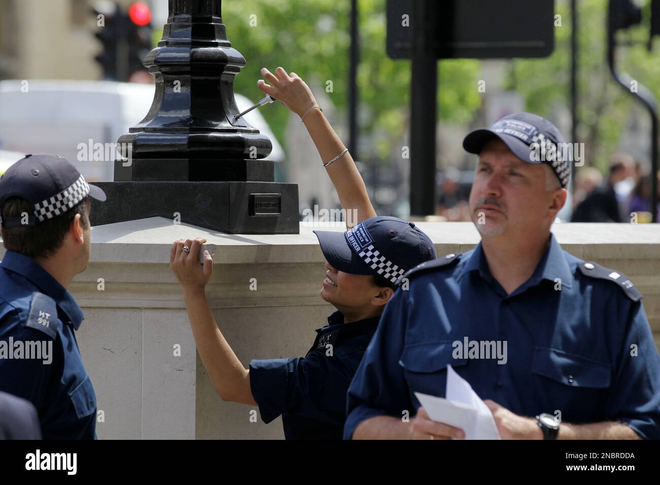 A Police officer checks a lamp post on Whitehall in London ahead of the ...