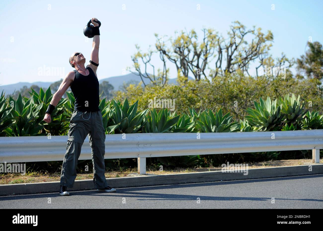 Tim Coyne of Culver City, Calif., lifts a kettle bell before his ...