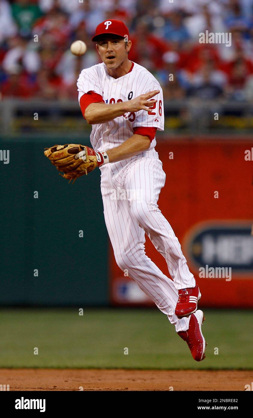 Philadelphia Phillies second baseman Chase Utley throws to first base ...