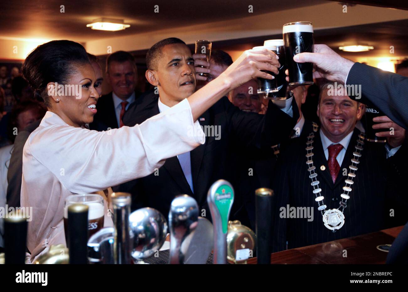 U.S. President Barack Obama and first lady Michelle Obama raise glasses ...