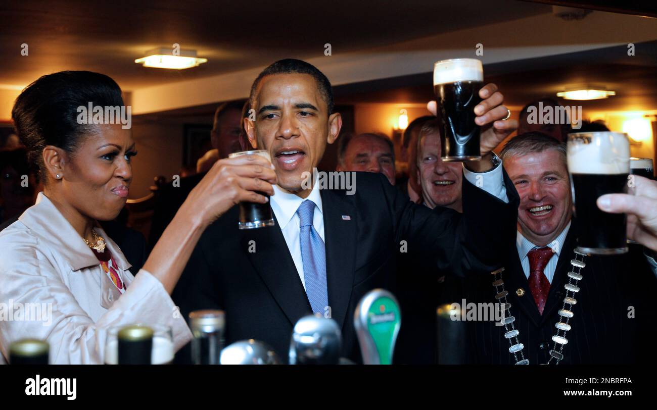 U.S. President Barack Obama and first lady Michelle Obama drink ...