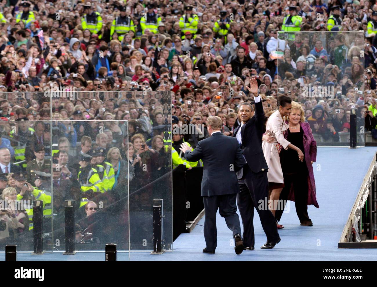 President Barack Obama, second from the left on stage, waves to the ...