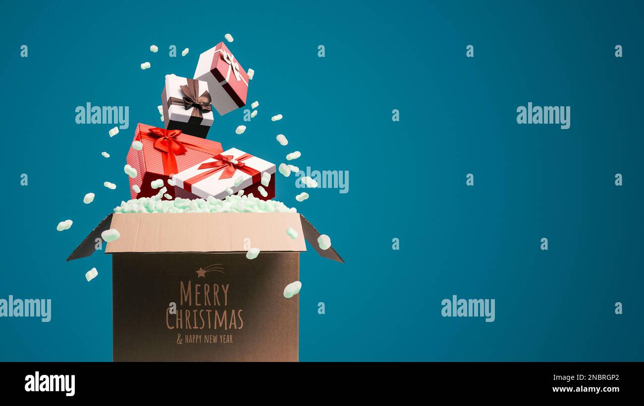 Beautiful Christmas gifts coming out from a delivery box and Christmas ...