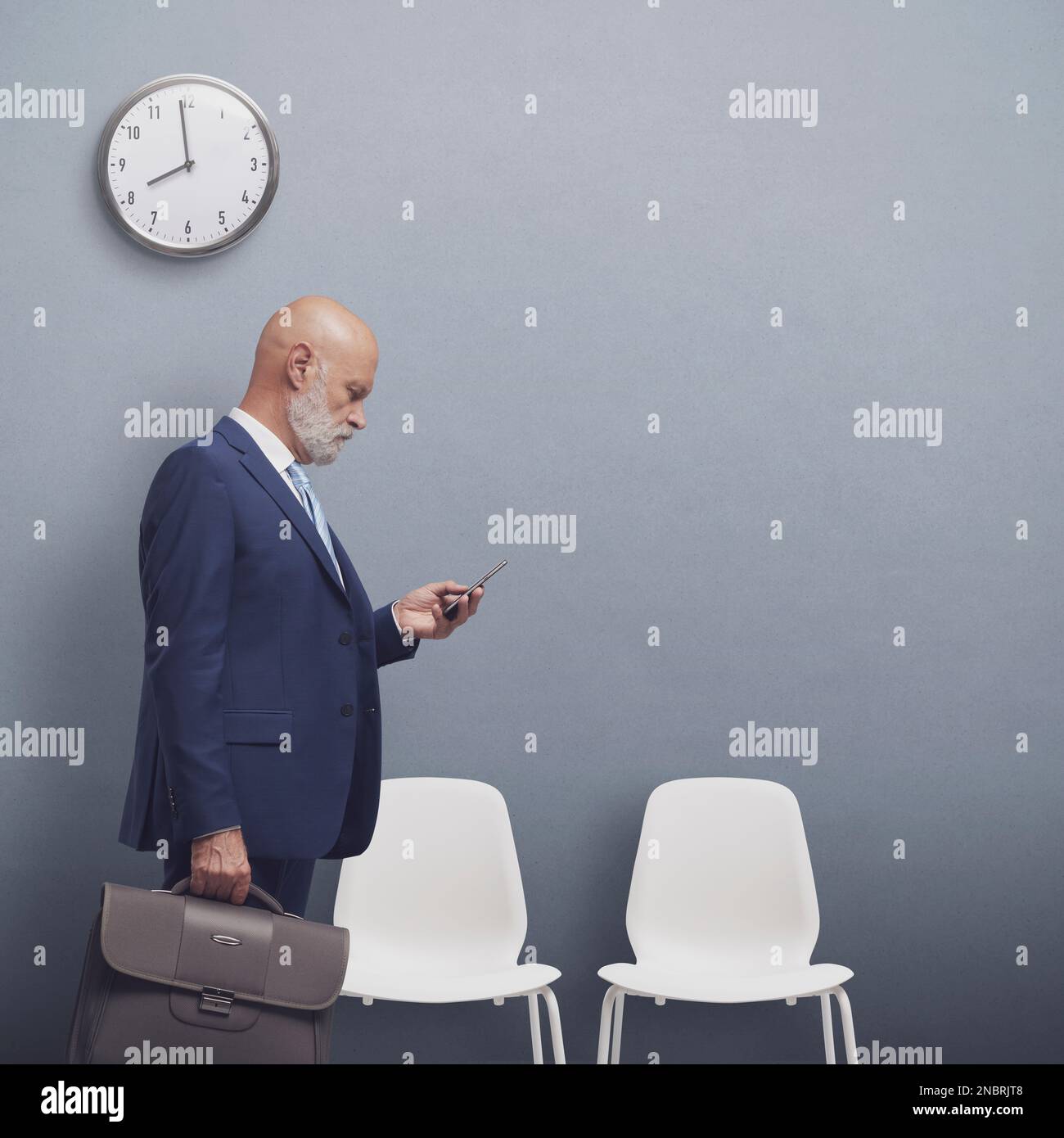 Corporate businessman standing in the waiting room, he is waiting for a ...