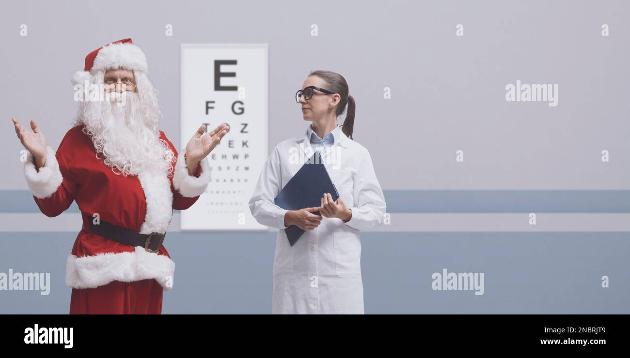Cheerful happy Santa Claus wearing glasses and having a vision test ...