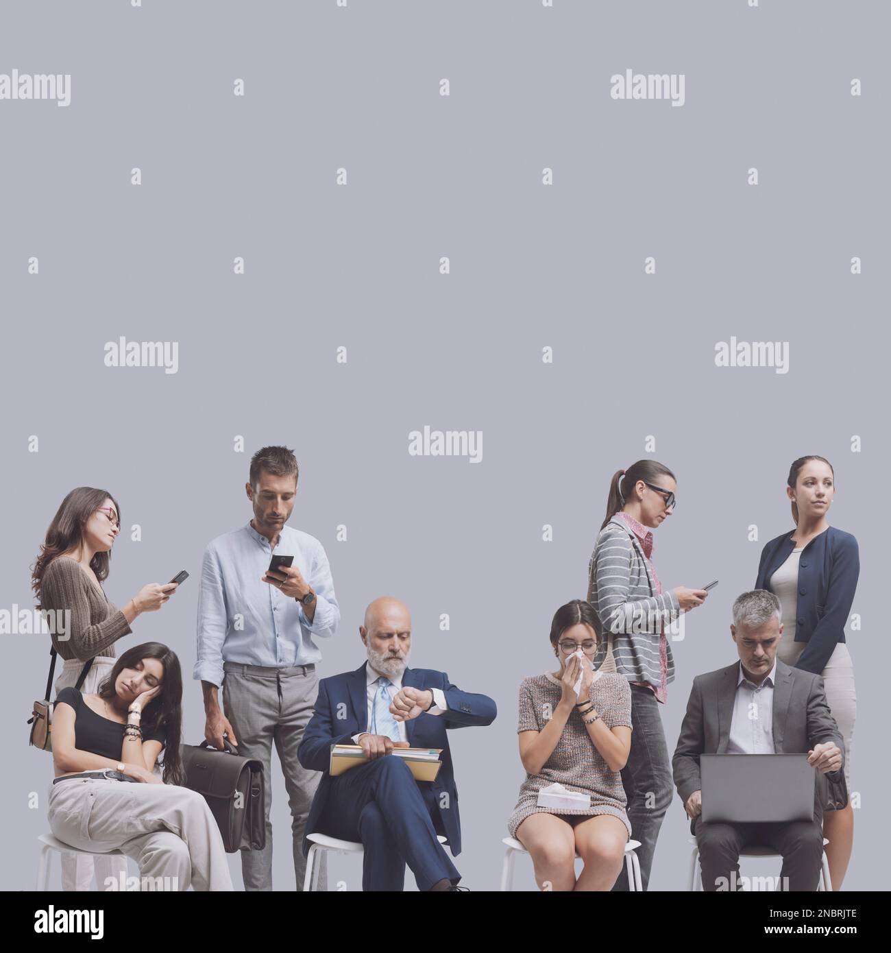 Crowd of people waiting for a job interview, they are busy with ...