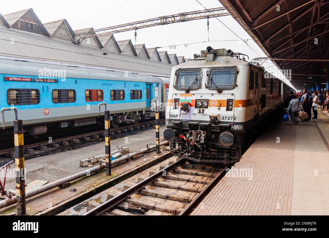 White Indian Railways train locomotive engine standing at a platform at ...