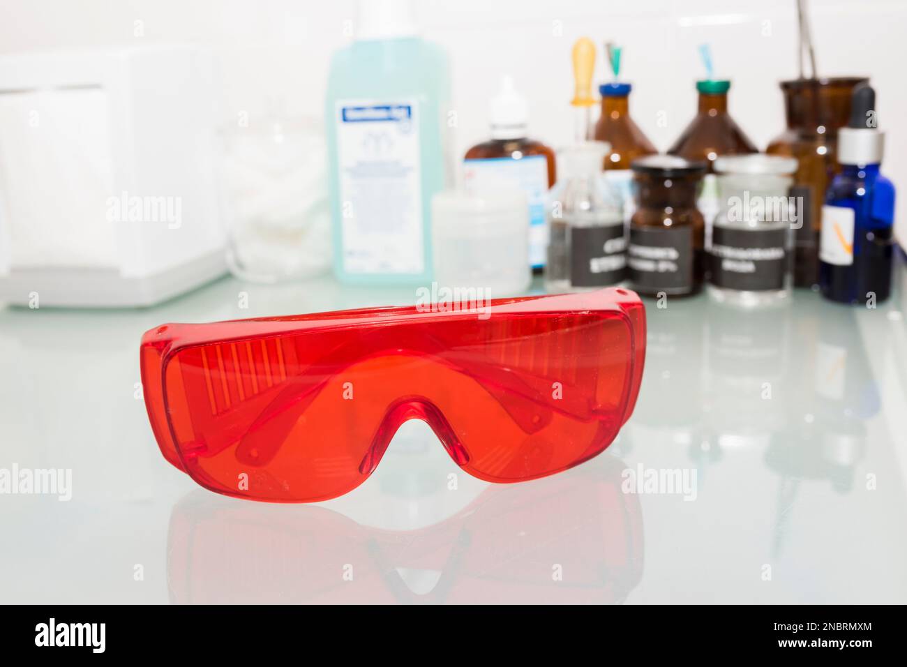 Red medical goggles on a medical table. Dental goggles Stock Photo - Alamy